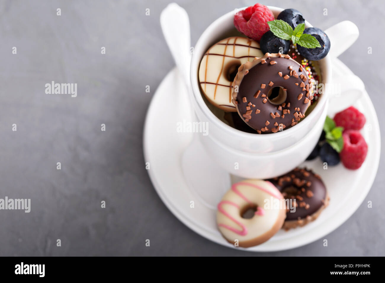 Small glazed mini donuts in stacked coffee cups Stock Photo - Alamy