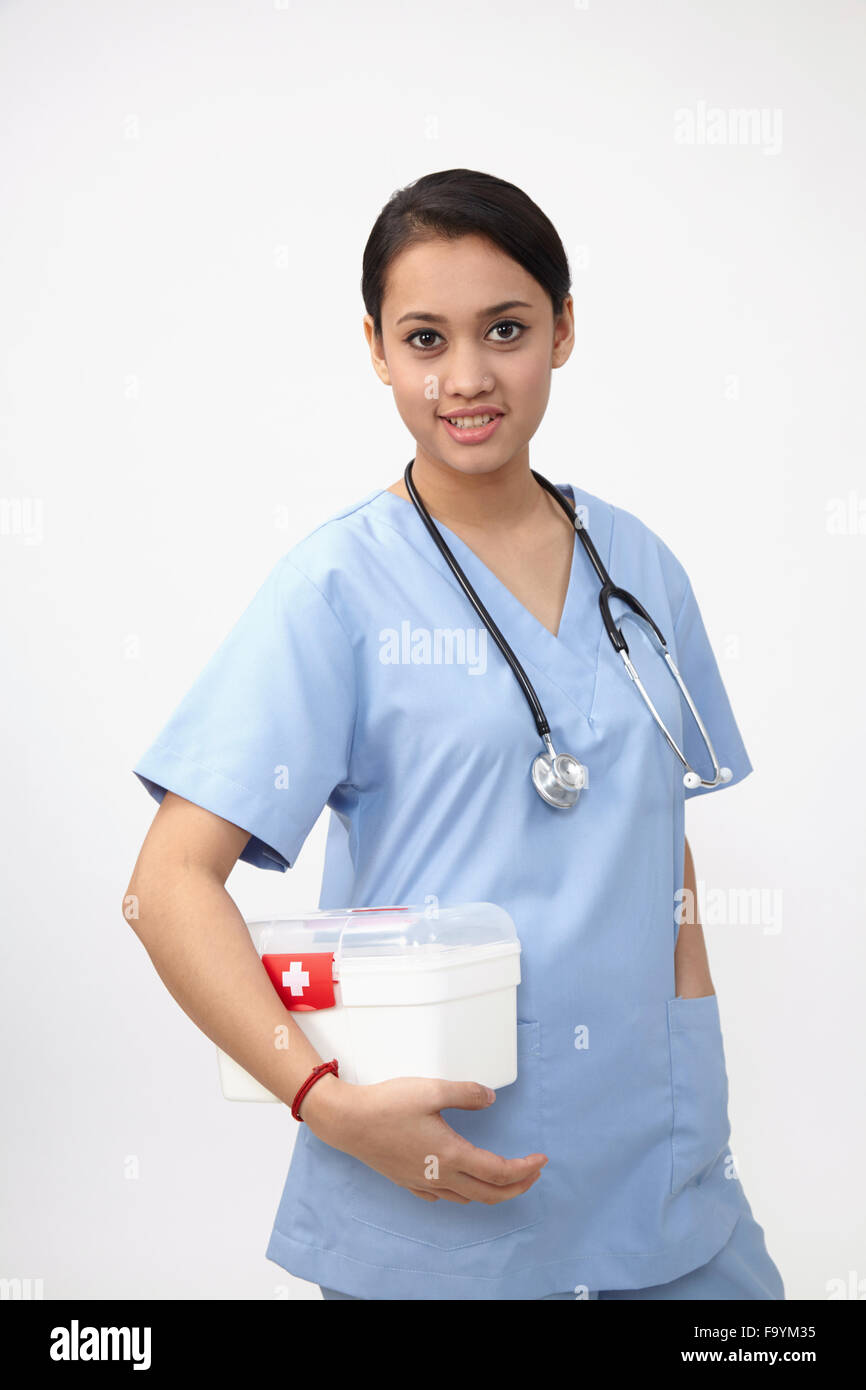 female nurse or doctor carrying a portable first aid kit isolated on ...