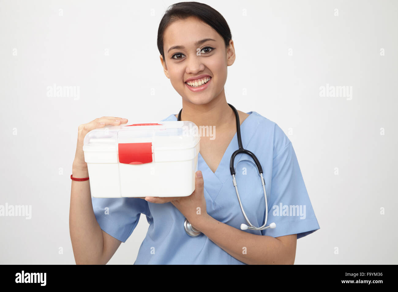 female nurse or doctor carrying a portable first aid kit isolated on ...