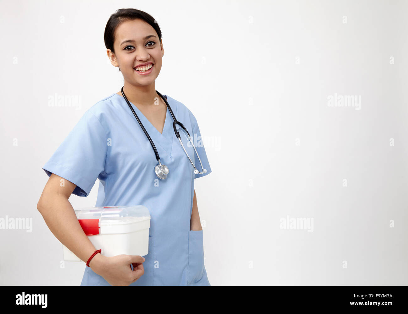 female nurse or doctor carrying a portable first aid kit isolated on ...