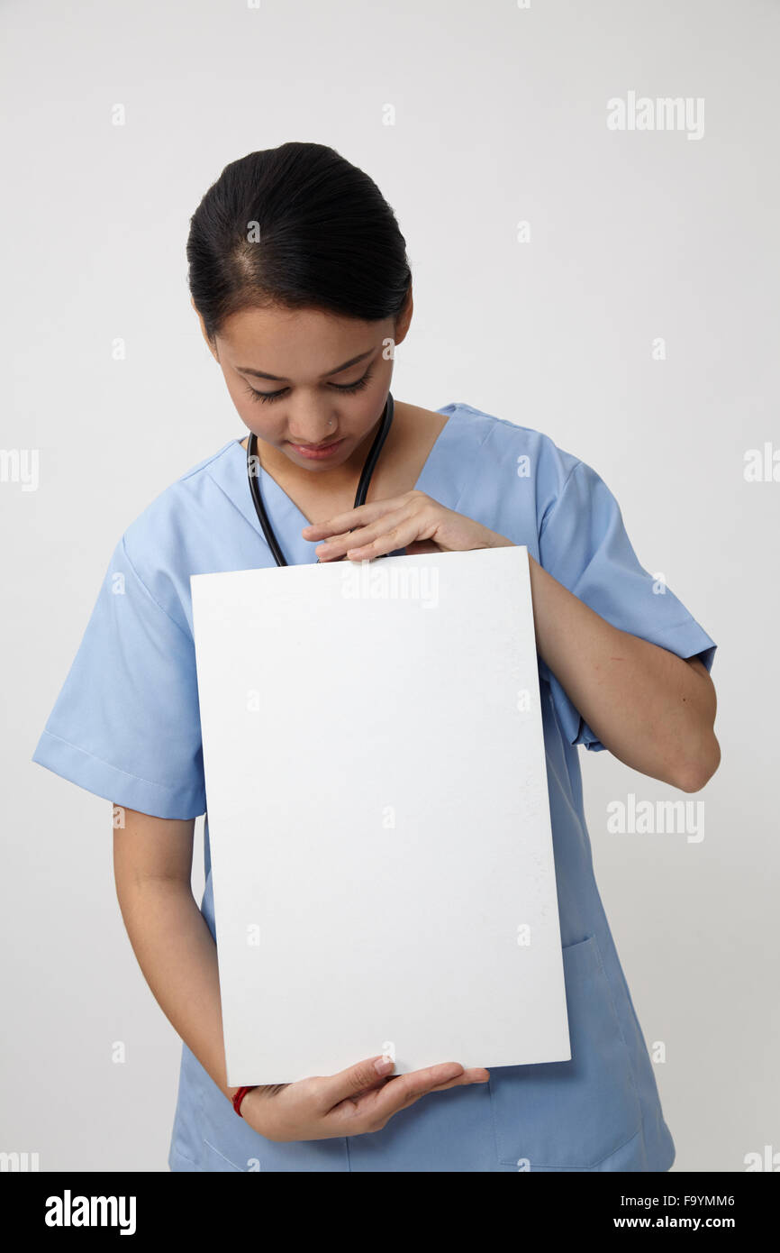 Nurse showing medical sign billboard standing, Young smiling woman ...