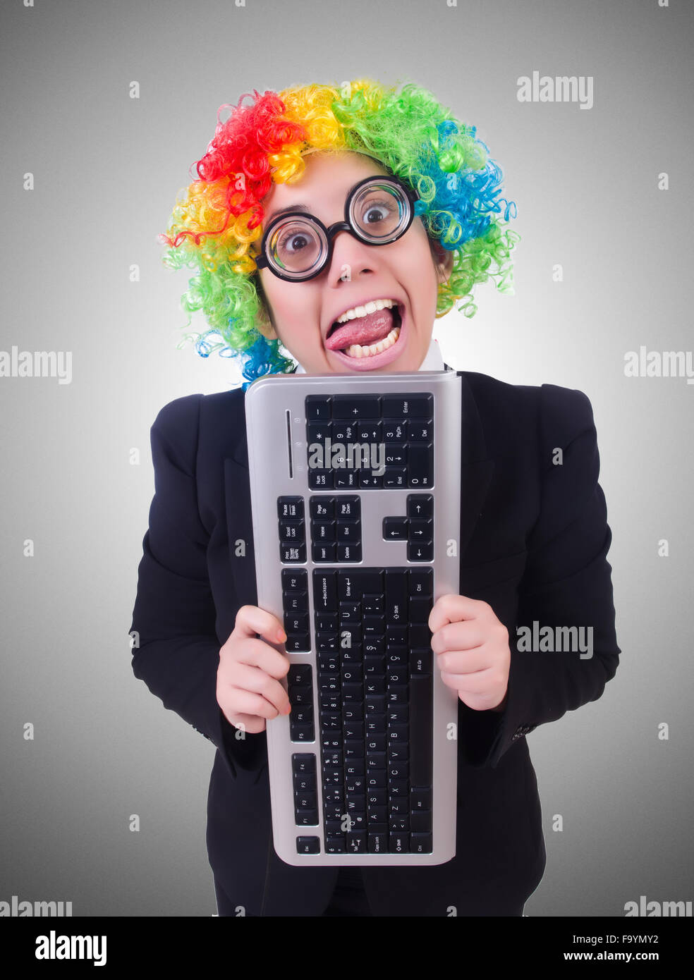 Funny clown with keyboard on white Stock Photo - Alamy