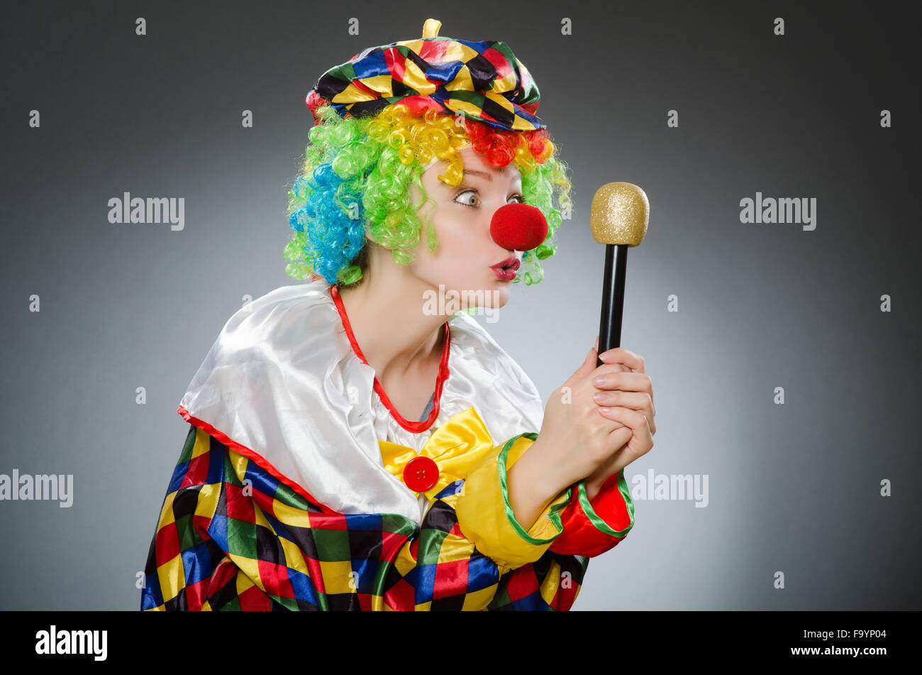 Clown with mic in funny concept Stock Photo - Alamy