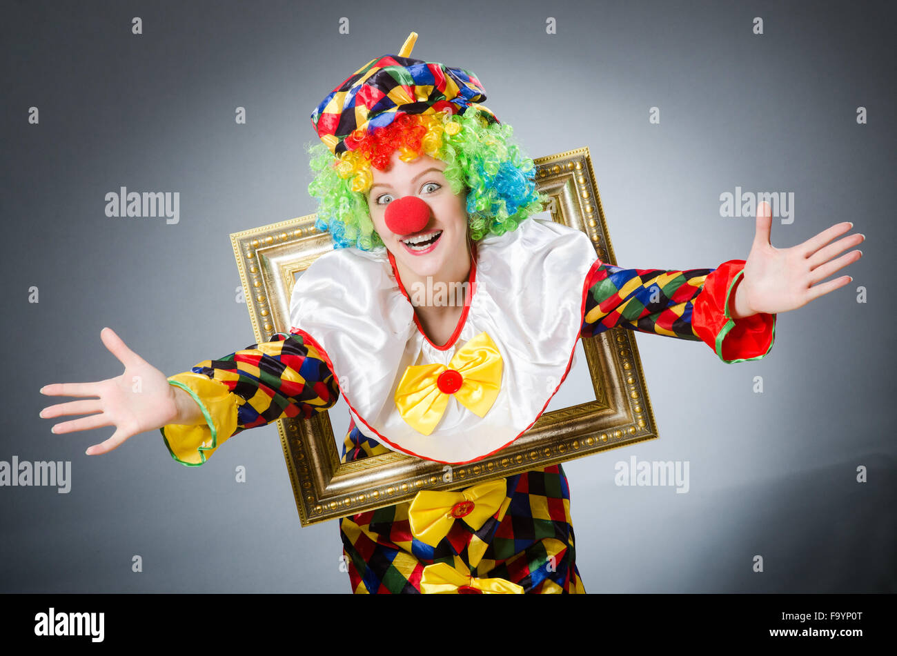 Clown with picture frame in funny concept Stock Photo - Alamy