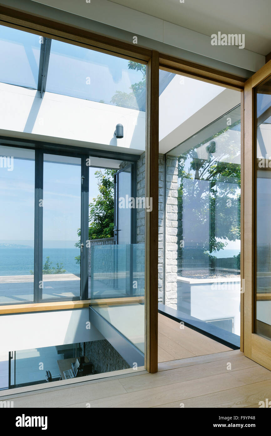 The interior spaces of a modern house on the cliffs overlooking the sea ...