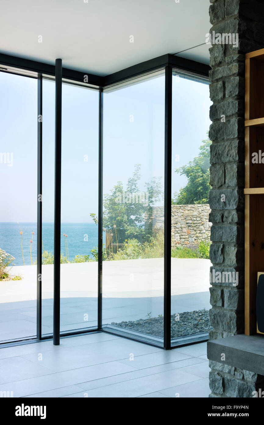 The interior spaces of a modern house on the cliffs overlooking the sea ...