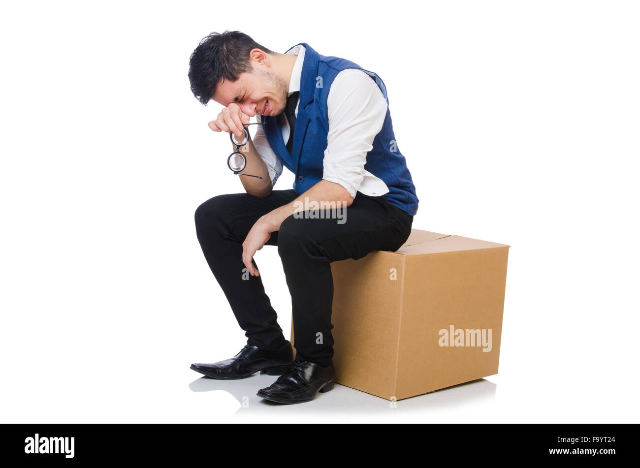 Young employee sitting on the box isolated on white Stock Photo - Alamy