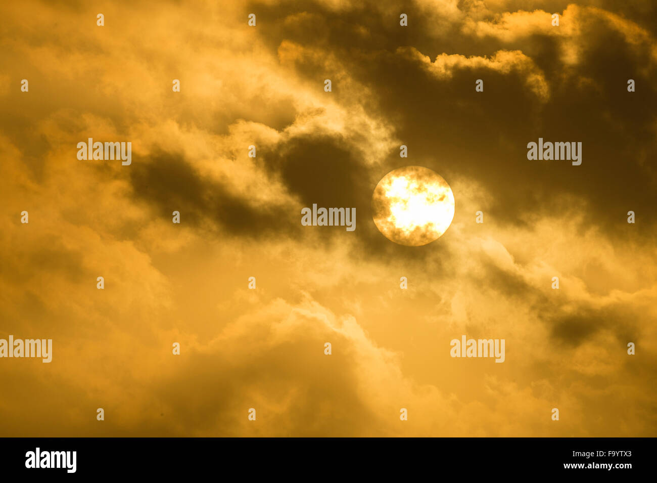 Sun shining behind cloud in hi-res stock photography and images - Alamy