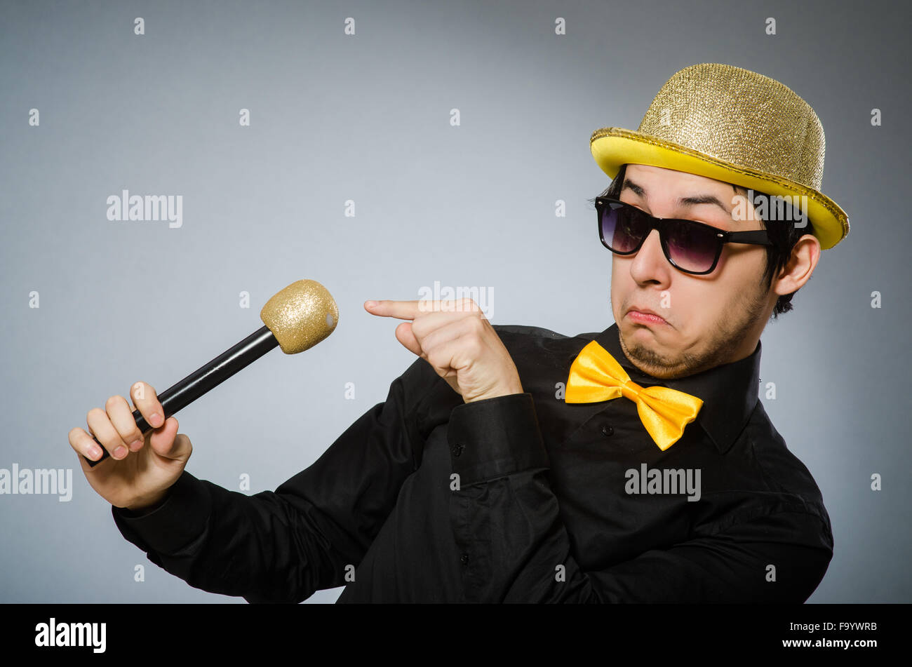 Funny man with mic in karaoke concept Stock Photo - Alamy