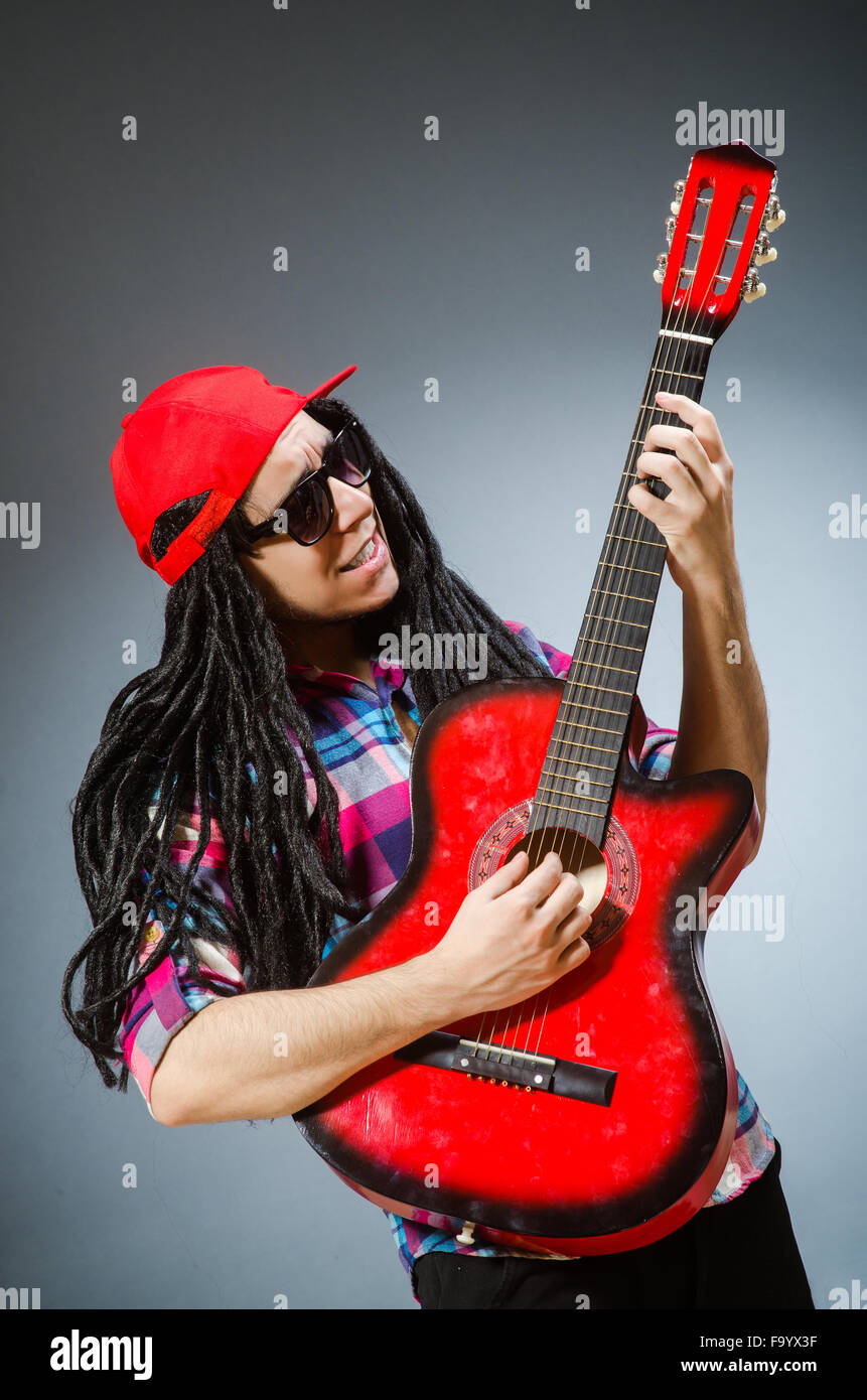 Funny man playing guitar in musical concept Stock Photo - Alamy