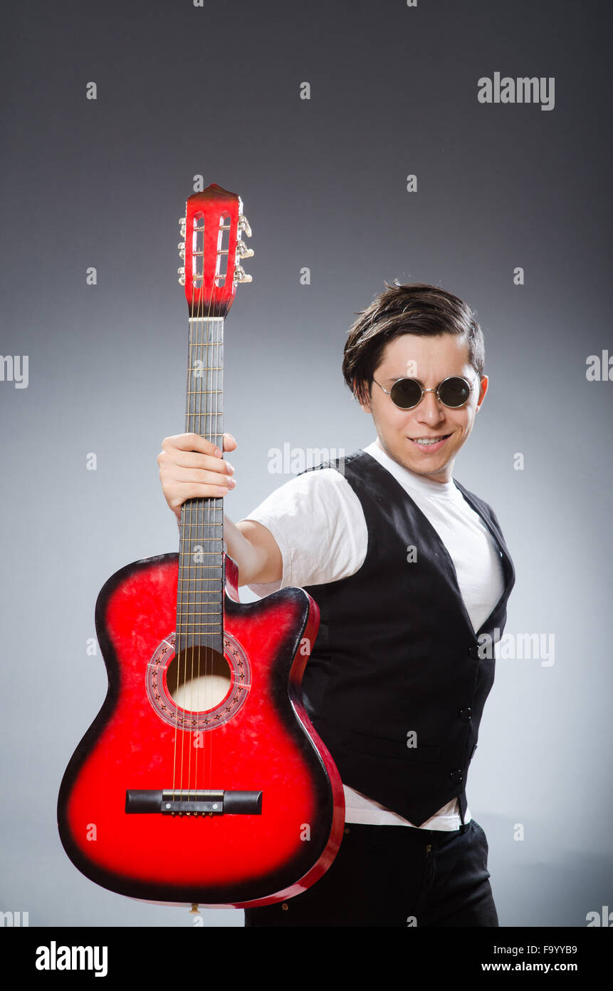 Funny guitar player in musical concept Stock Photo - Alamy