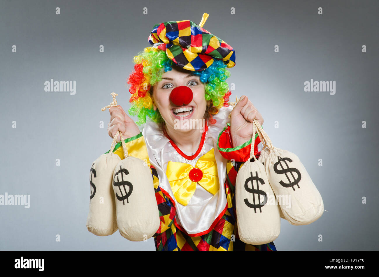 Clown with money bag in funny concept Stock Photo - Alamy