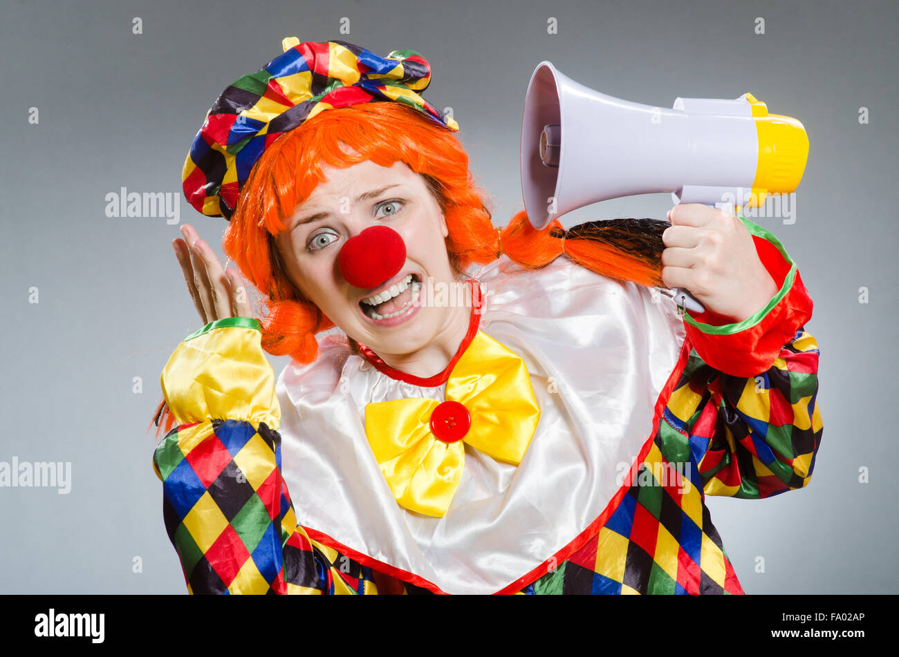 Clown with loudspeaker isolated on white Stock Photo - Alamy