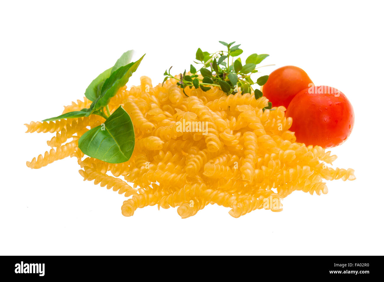 Spiral macaroni with basil and tomato Stock Photo - Alamy