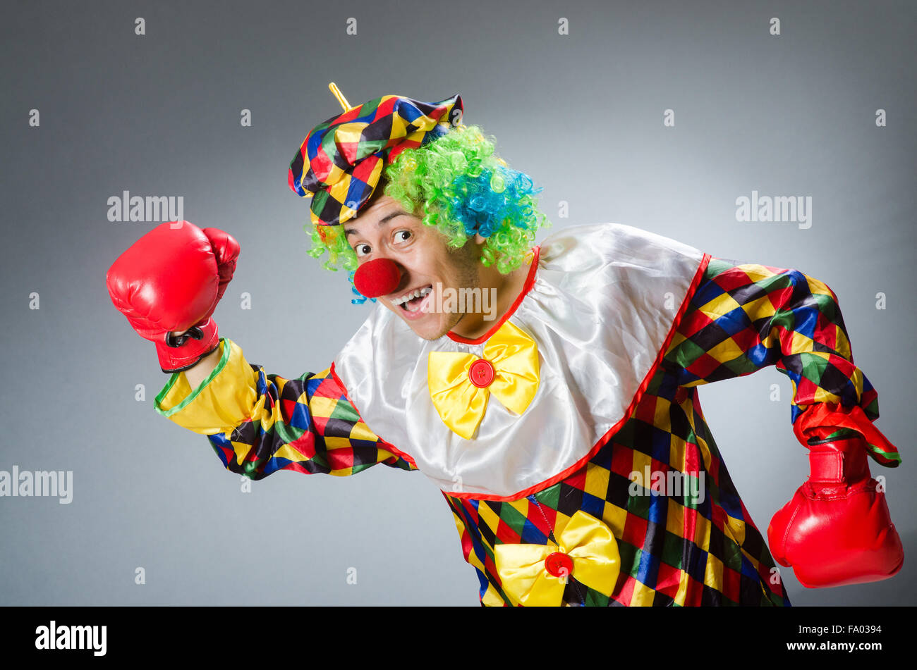 Clown with boxing gloves isolated on white Stock Photo - Alamy