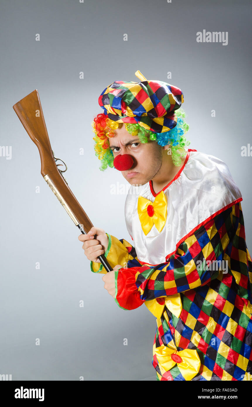 Clown with rifle isolated on white Stock Photo - Alamy