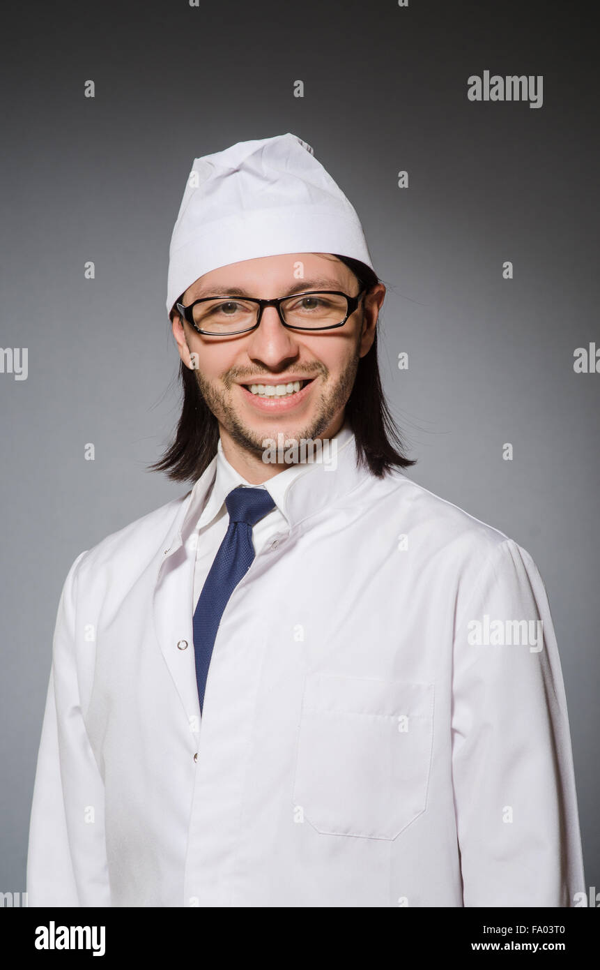 Male doctor against gray Stock Photo - Alamy
