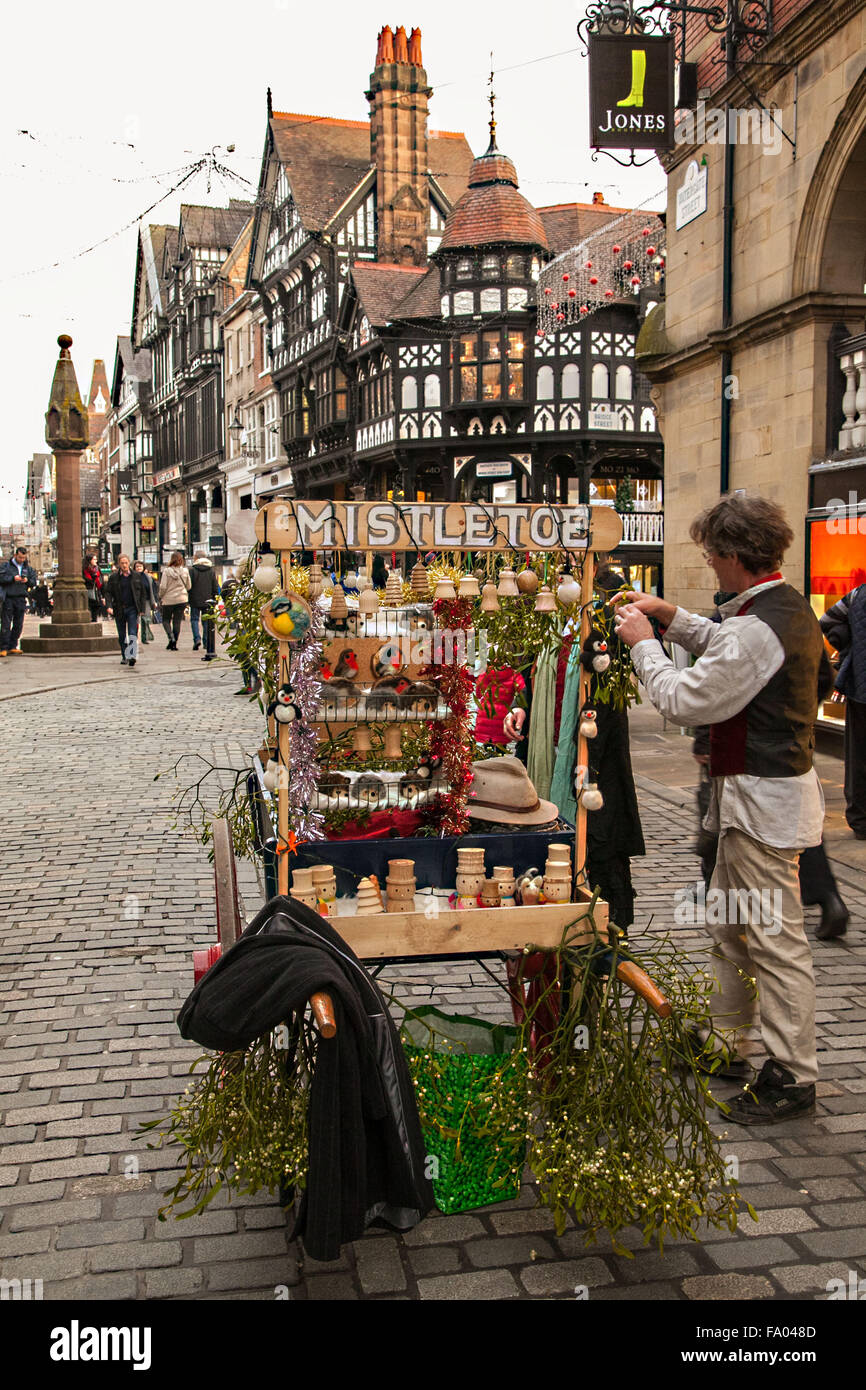 Christmas Street scene of man selling mistletoe from a barrow Chester ...
