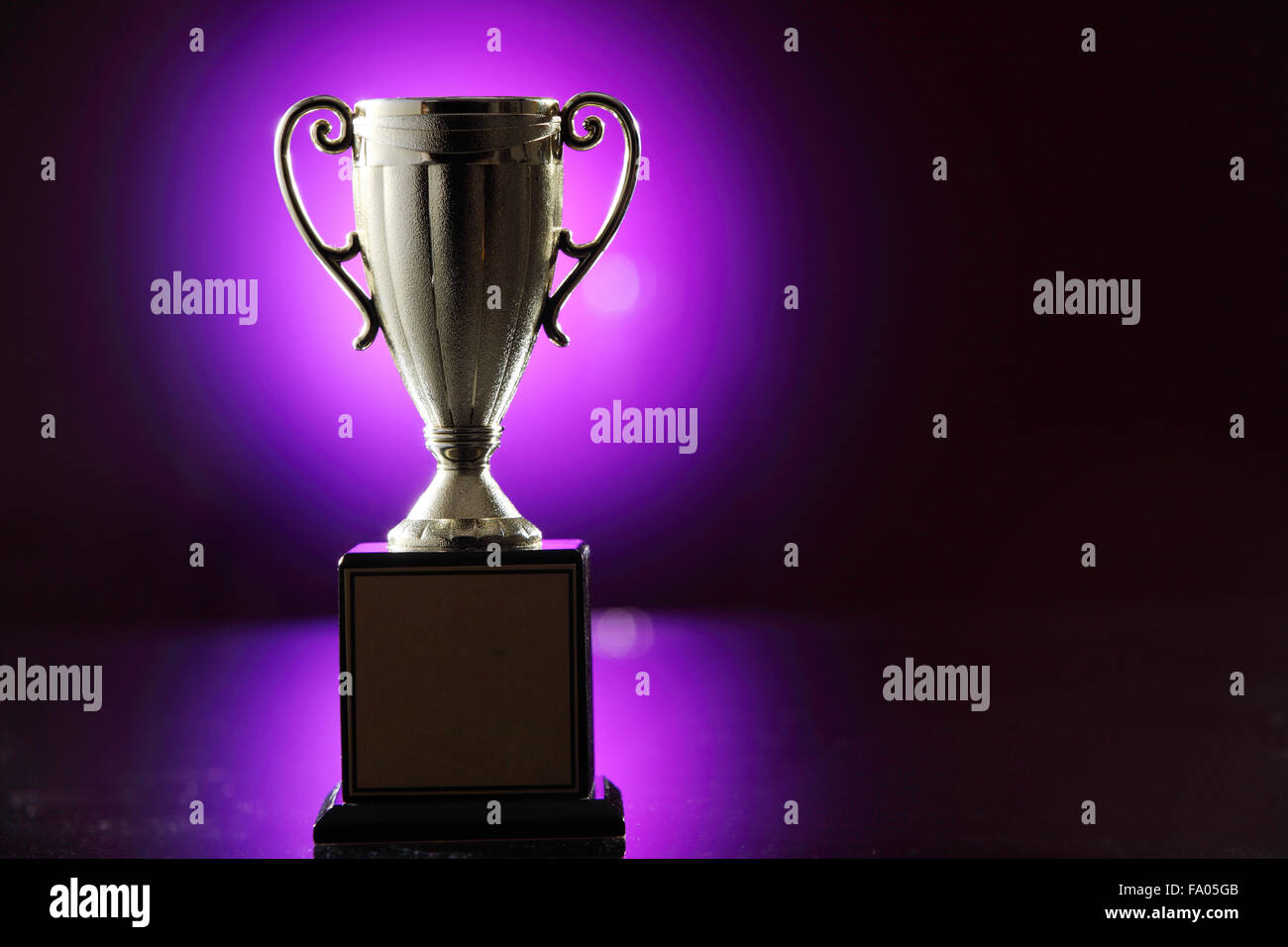 golden trophy on the purple background Stock Photo - Alamy