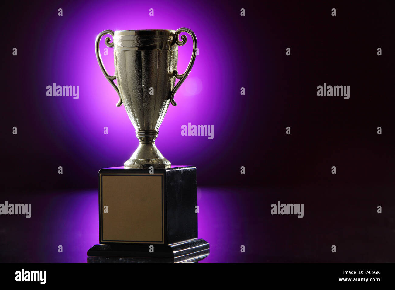 golden trophy on the purple background Stock Photo - Alamy