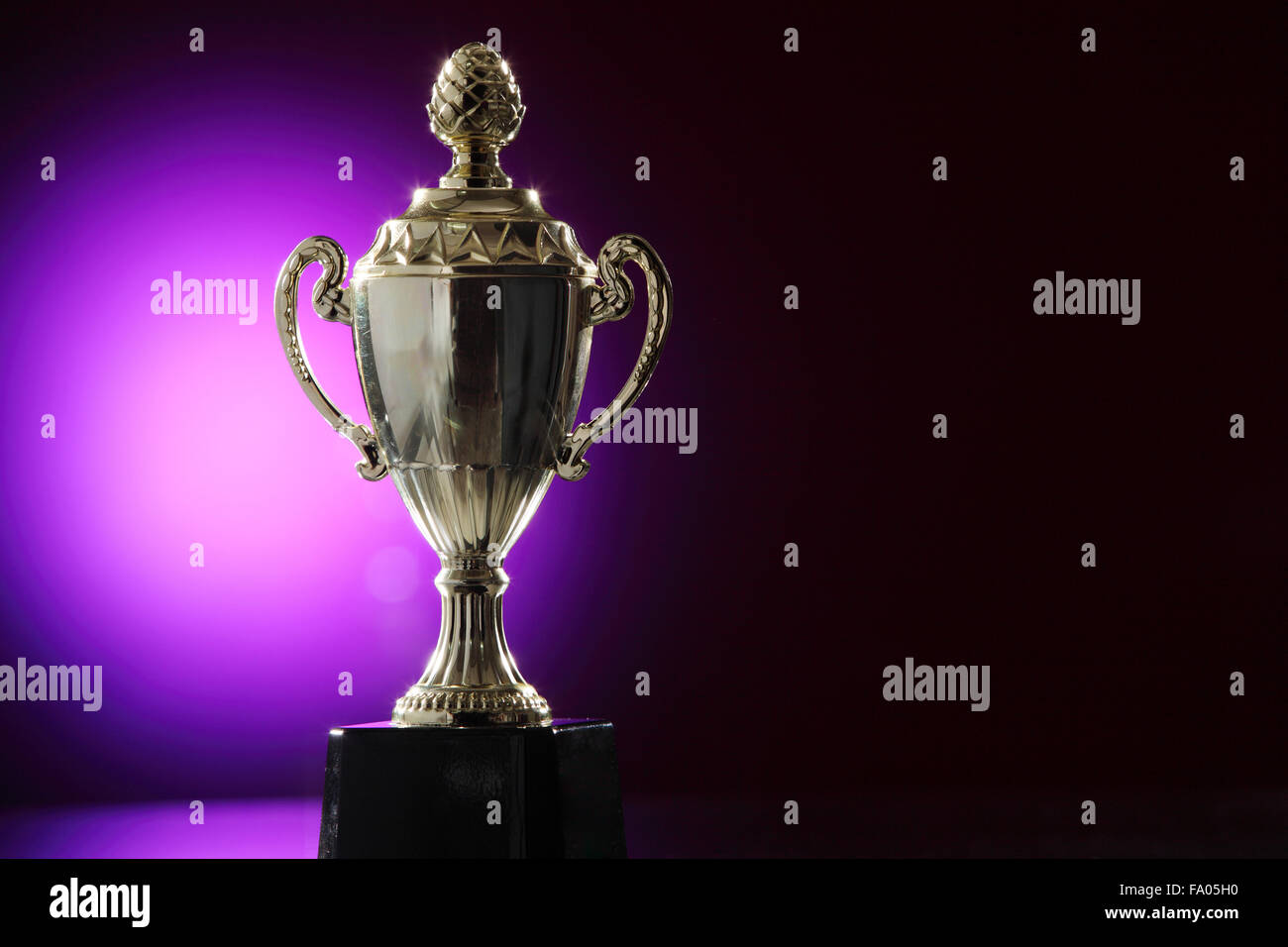 golden trophy on the purple background Stock Photo - Alamy