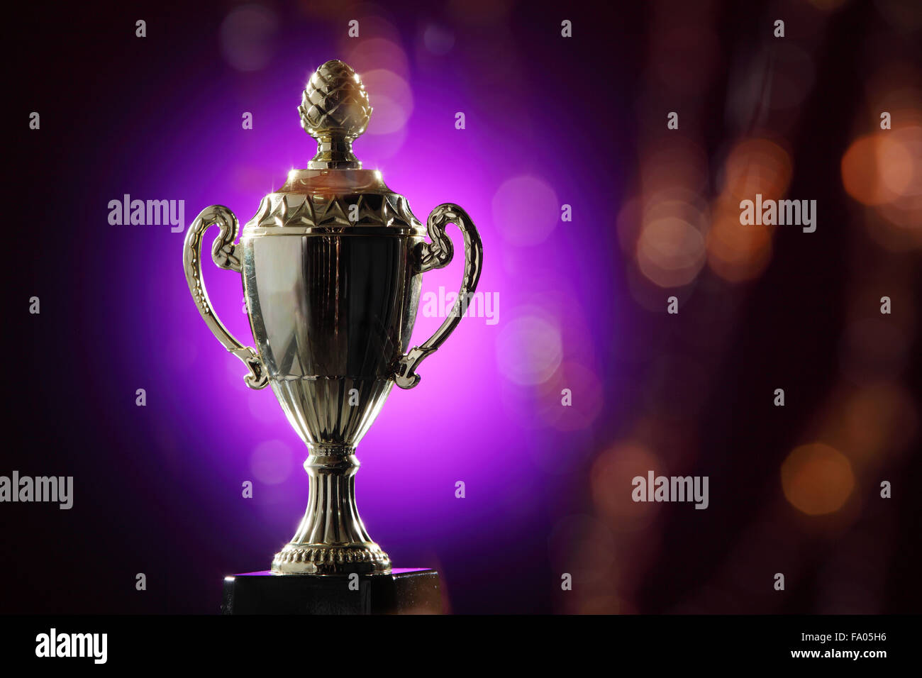 golden trophy on the purple background Stock Photo - Alamy