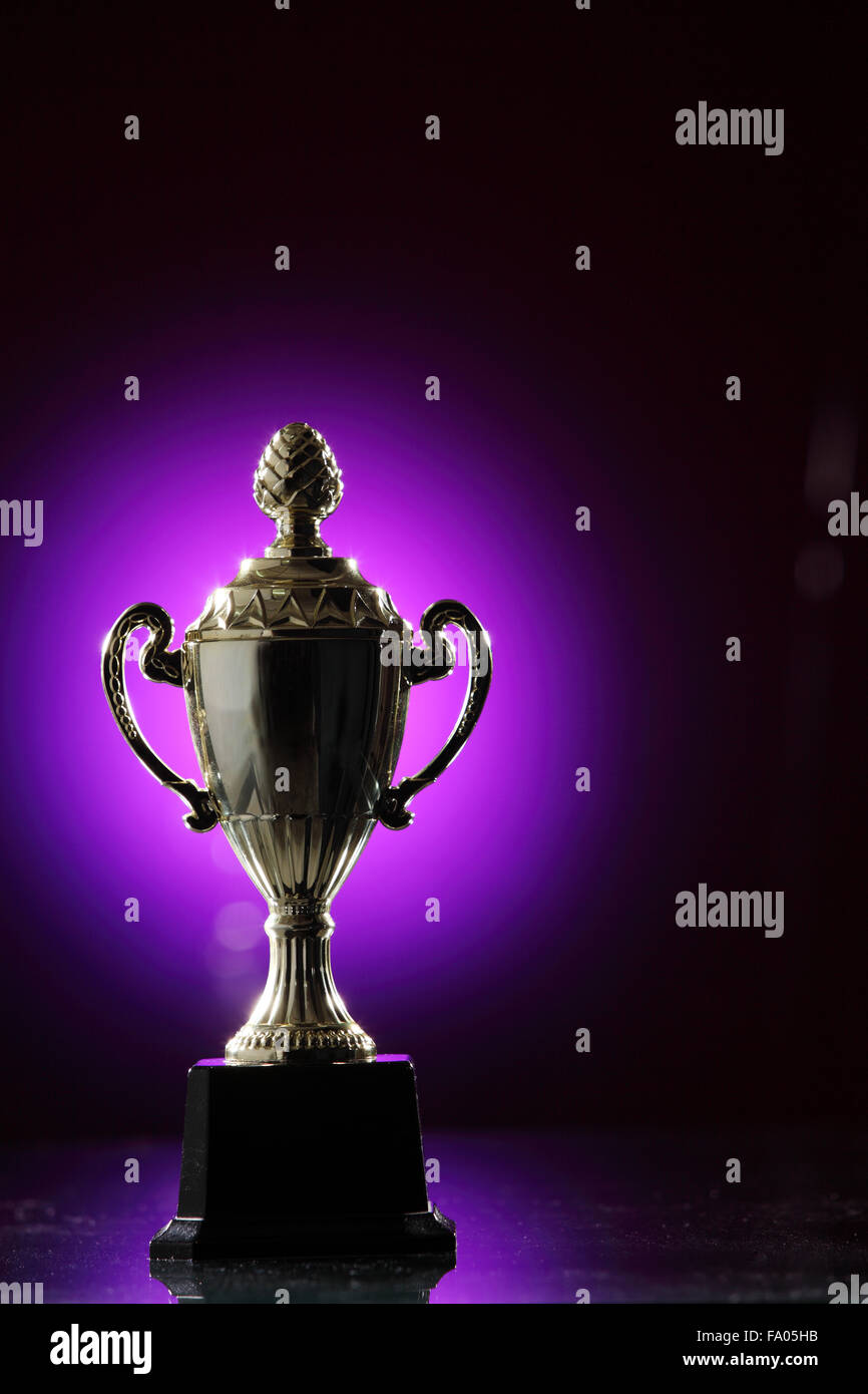 golden trophy on the purple background Stock Photo - Alamy