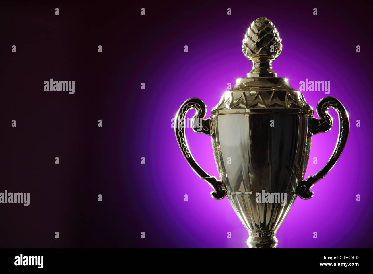 golden trophy on the purple background Stock Photo - Alamy