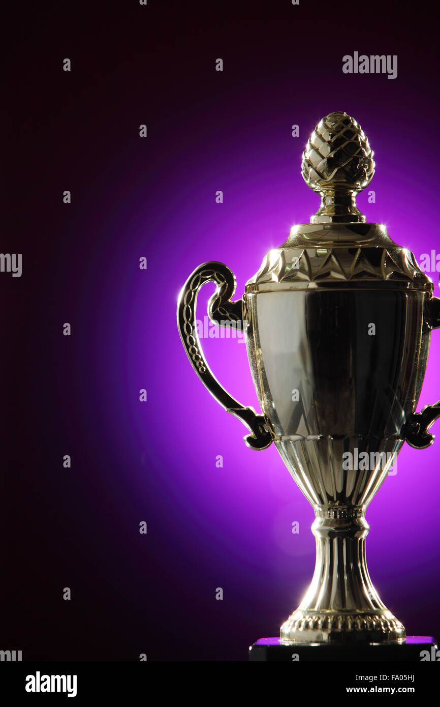 golden trophy on the purple background Stock Photo - Alamy