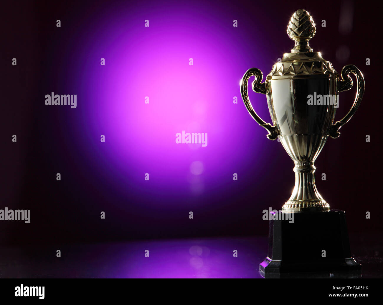 golden trophy on the purple background Stock Photo - Alamy