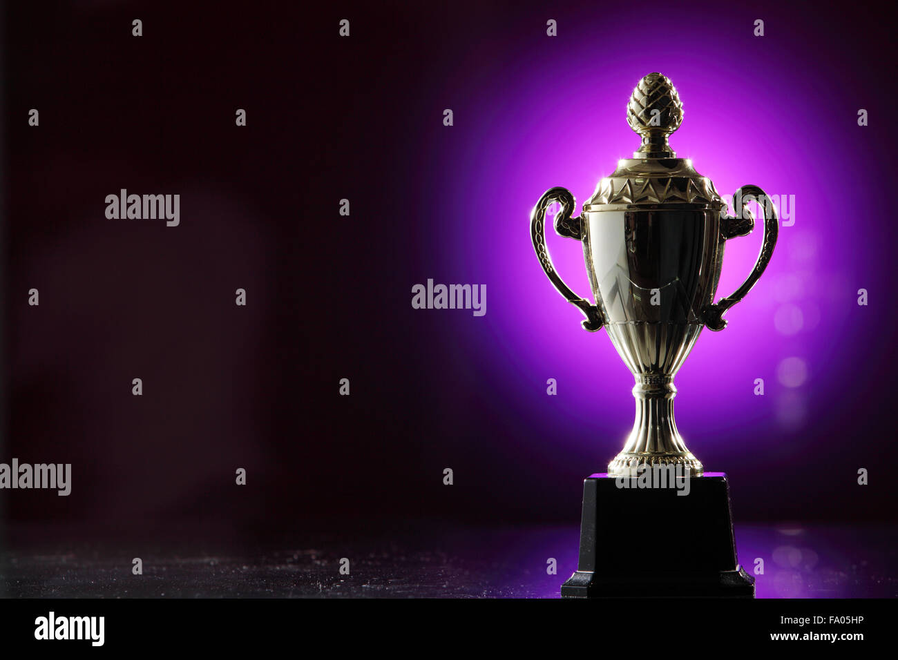golden trophy on the purple background Stock Photo - Alamy