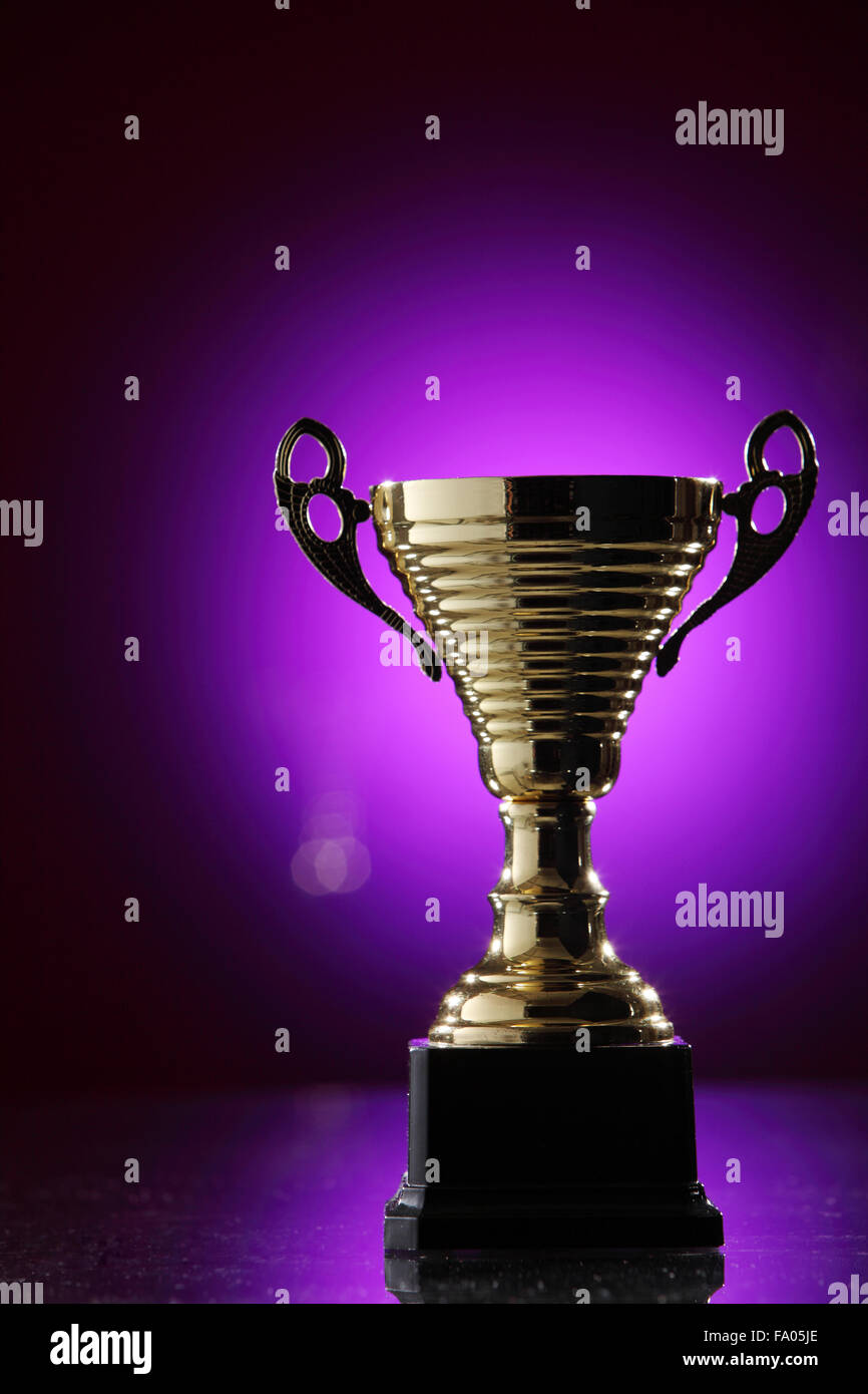 golden trophy on the purple background Stock Photo - Alamy