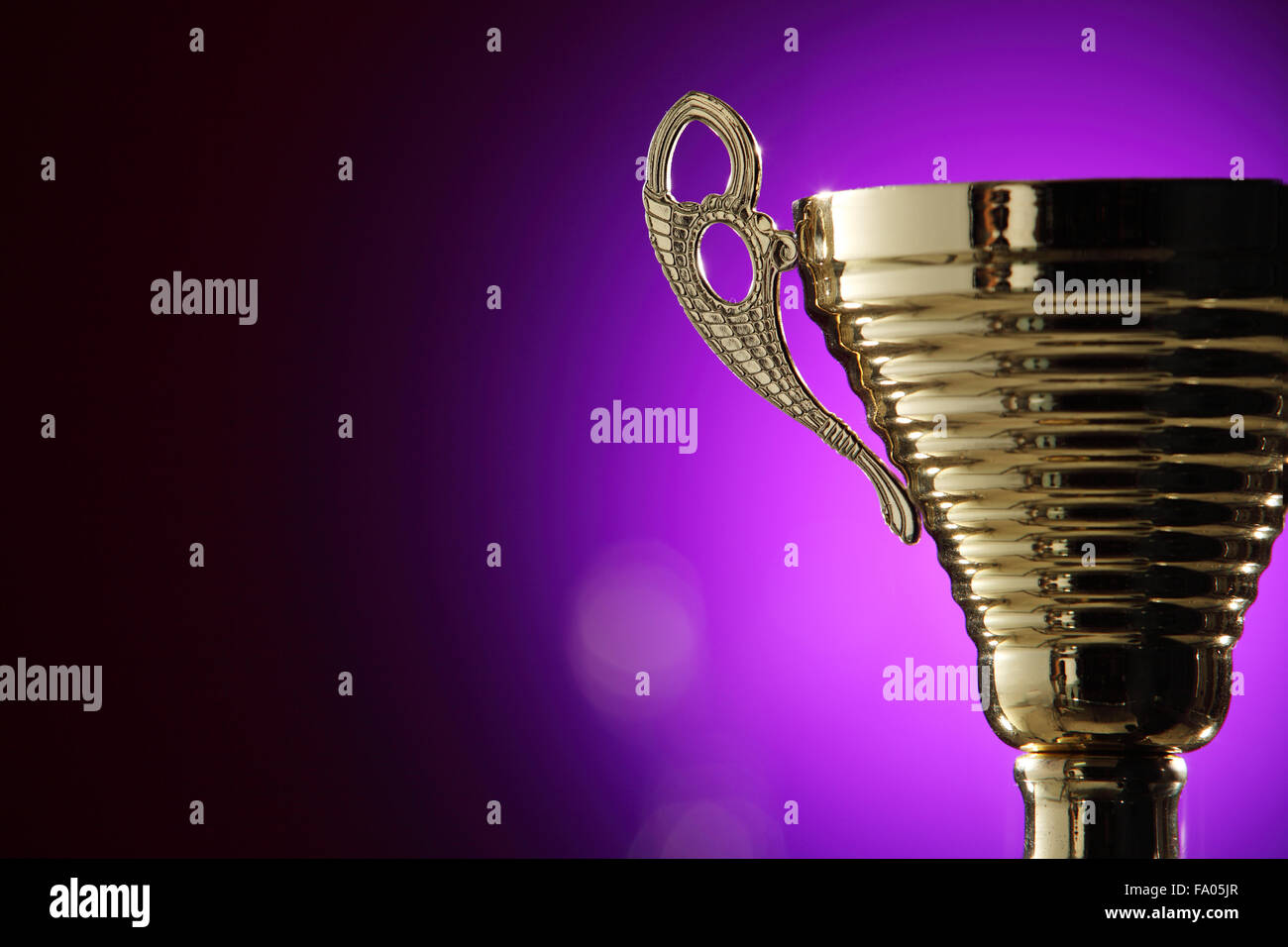 golden trophy on the purple background Stock Photo - Alamy