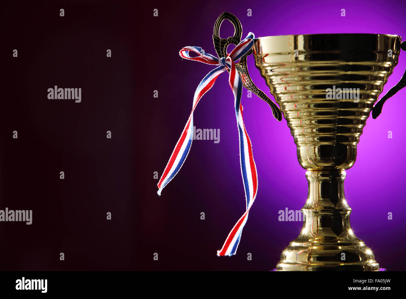 golden trophy on the purple background Stock Photo - Alamy