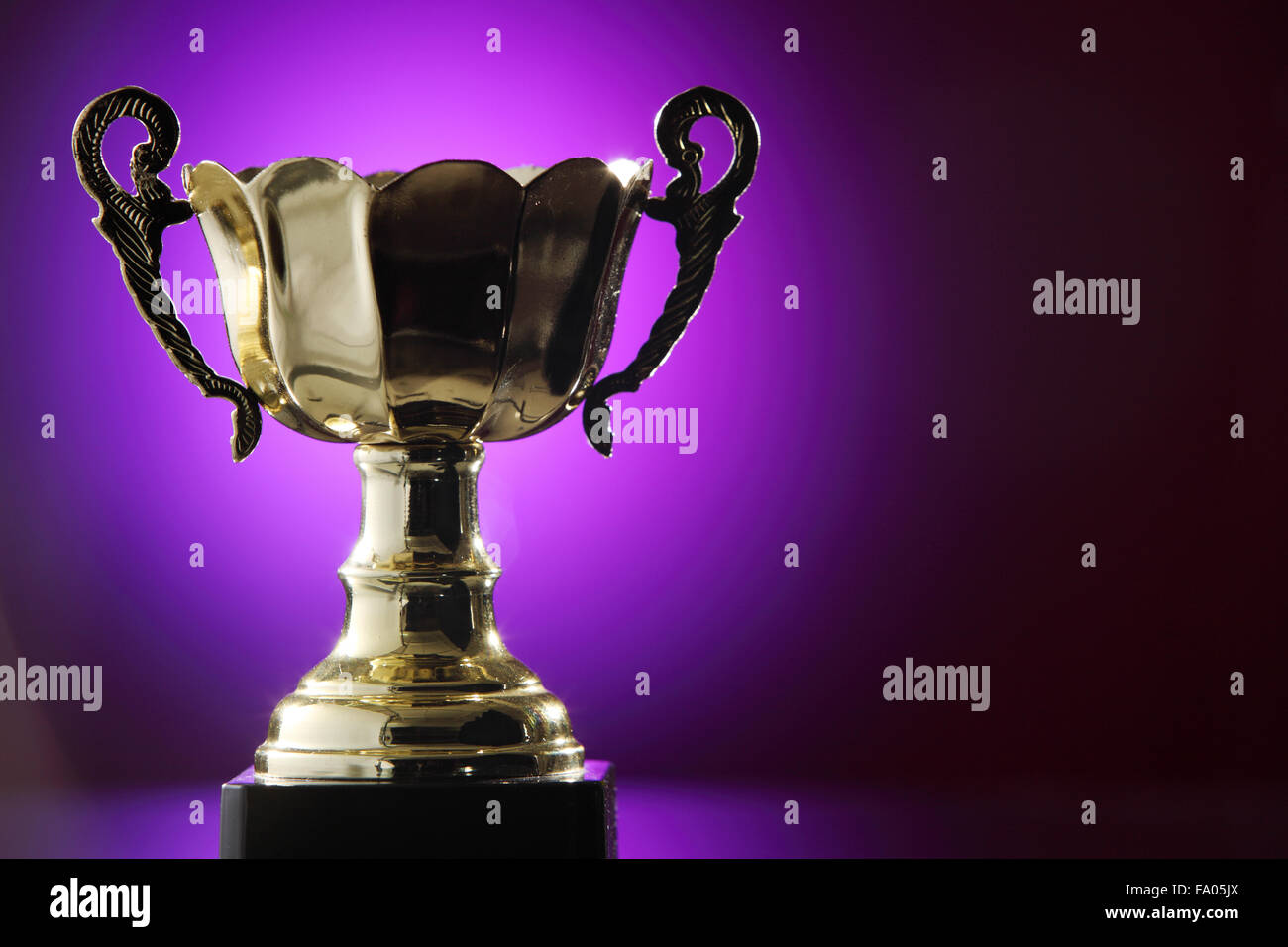 golden trophy on the purple background Stock Photo - Alamy