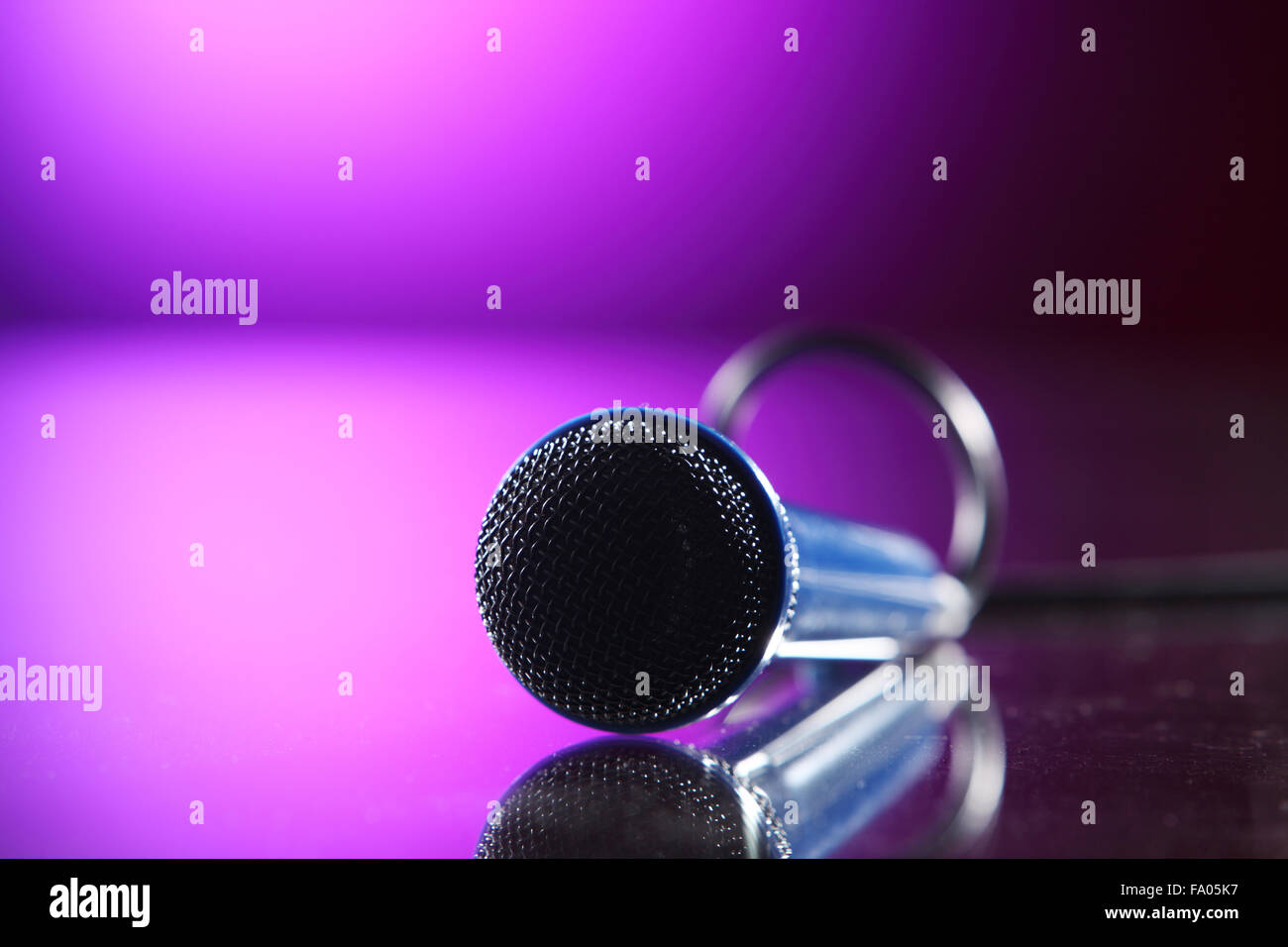 microphone with cable on the purple background Stock Photo - Alamy
