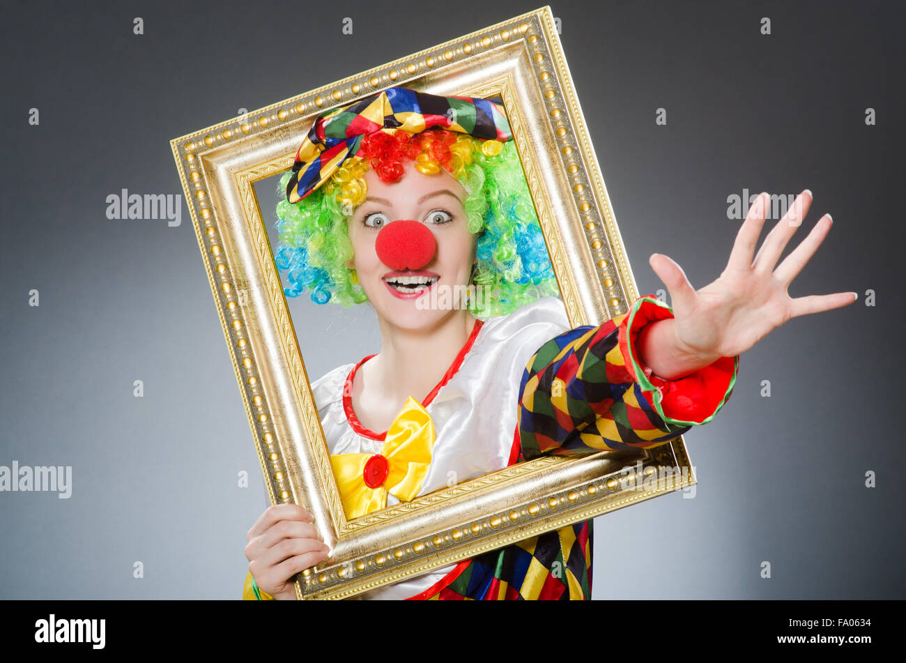 Clown with picture frame in funny concept Stock Photo - Alamy