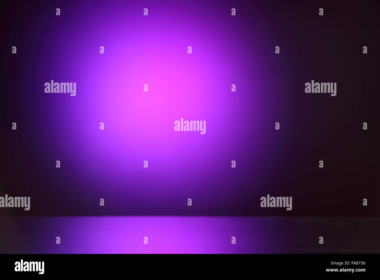 light spot on the purple background Stock Photo - Alamy