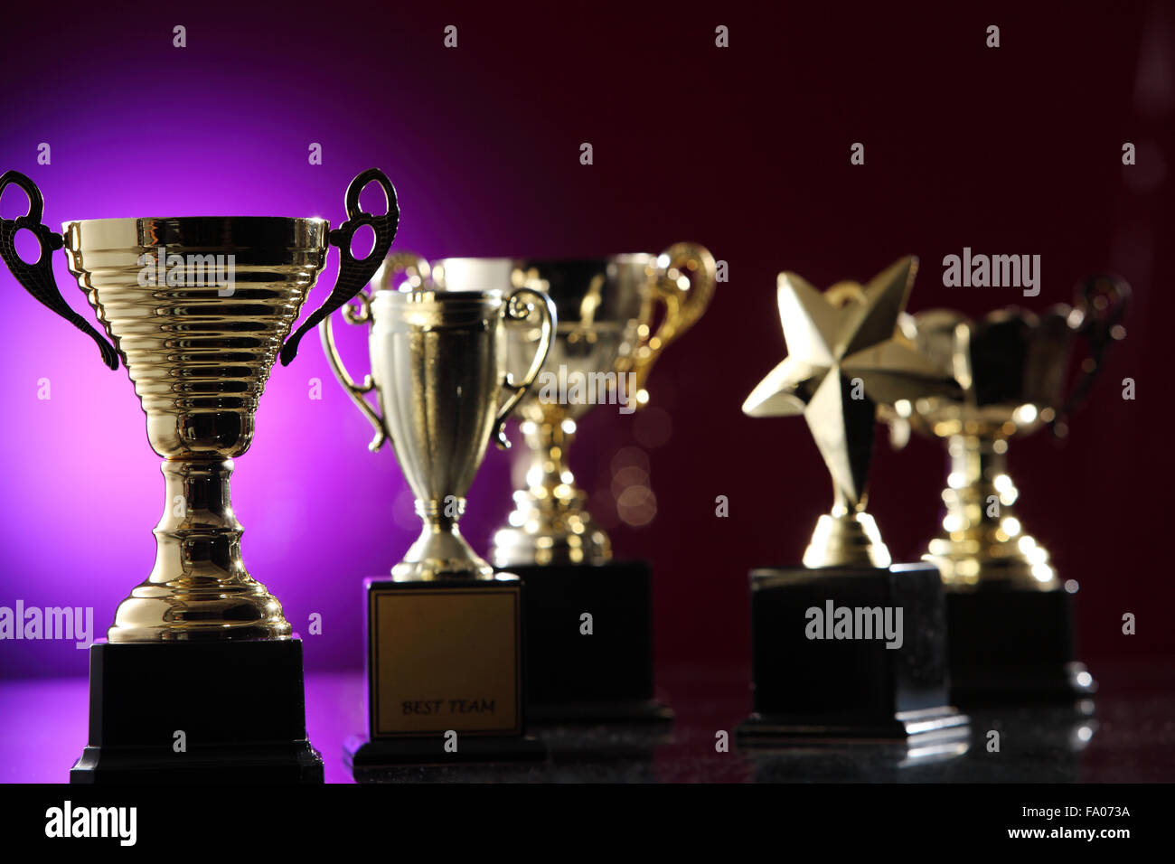 group of the trophy with purple background Stock Photo - Alamy