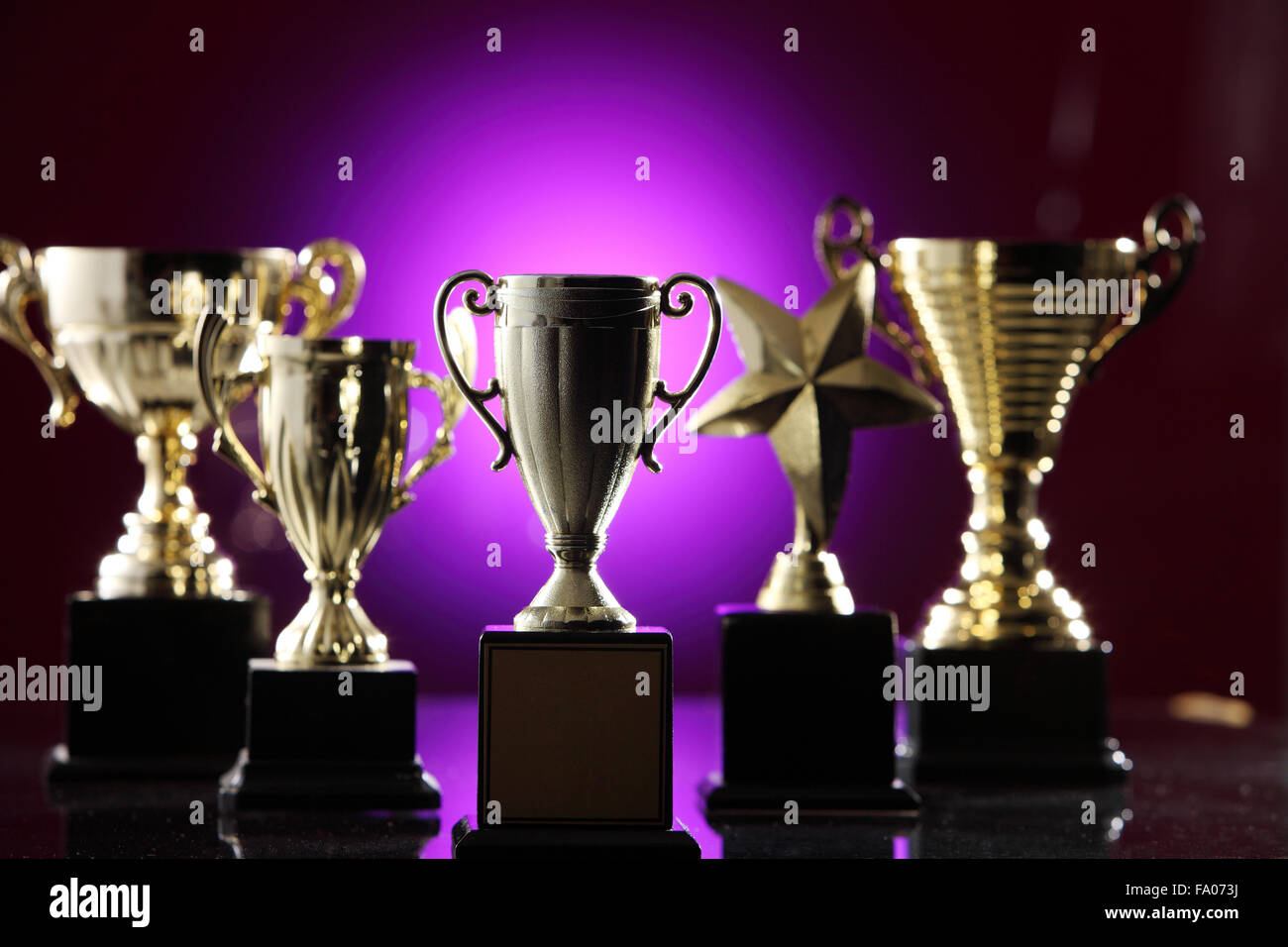 group of the trophy with purple background Stock Photo - Alamy