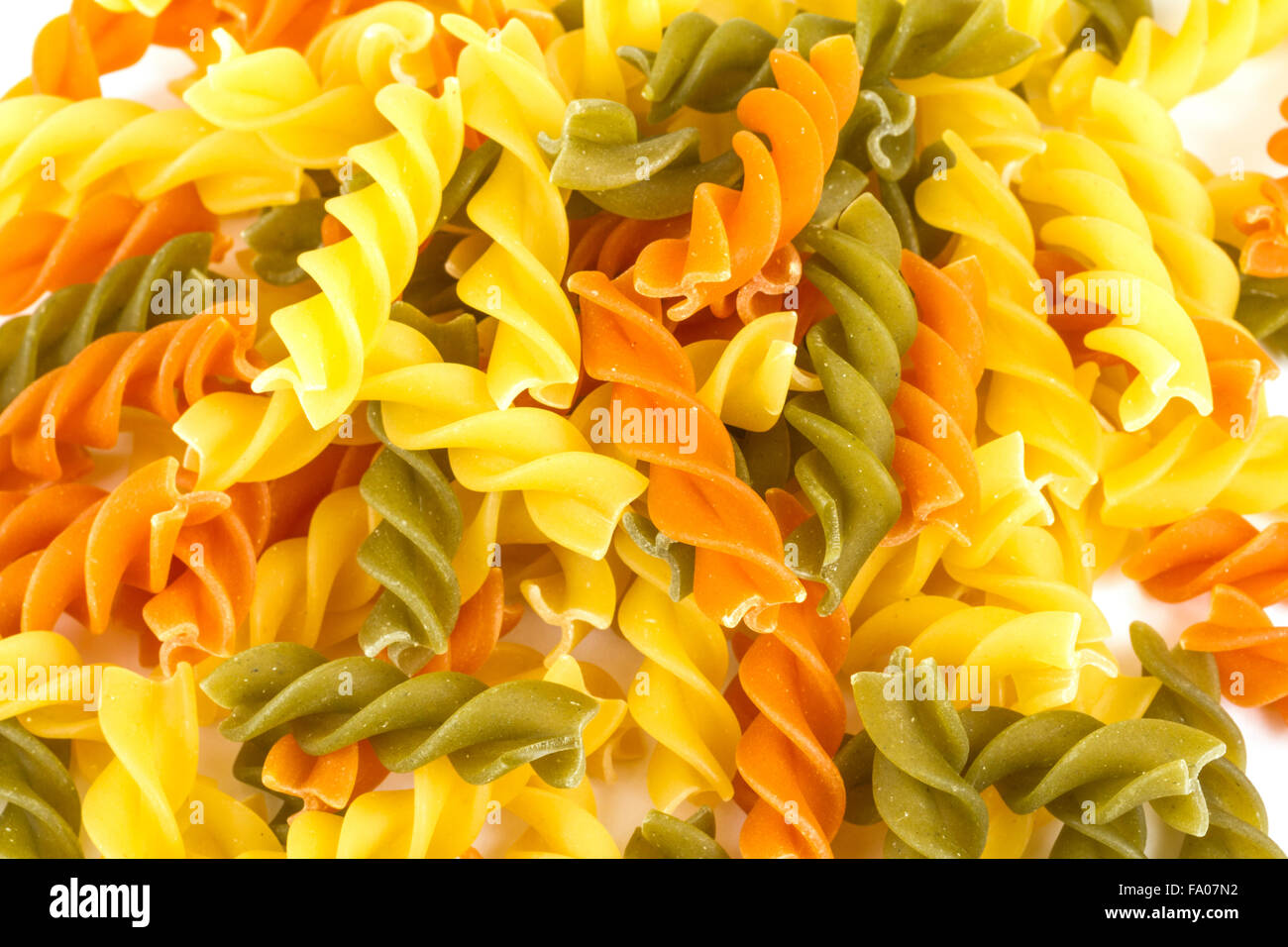 Uncooked pasta fusilli in different colours, white background Stock ...