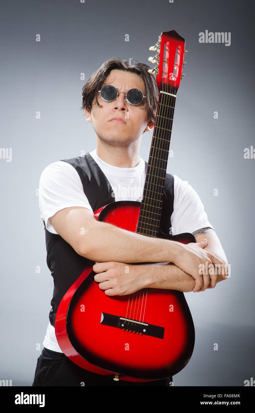 Funny guitar player in musical concept Stock Photo - Alamy