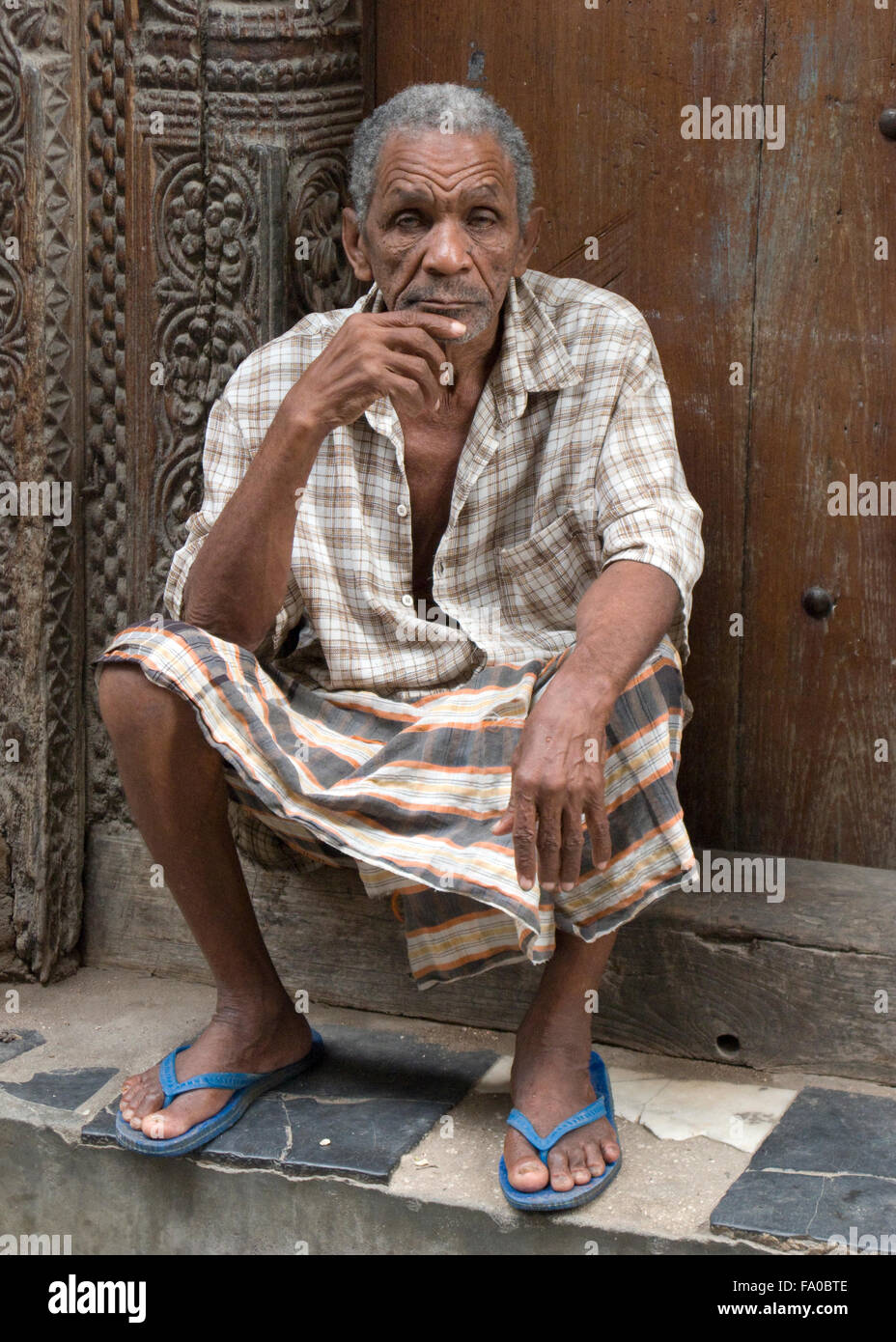 Thoughtful Old Man on his Doorstep Zanzibar Stock Photo - Alamy