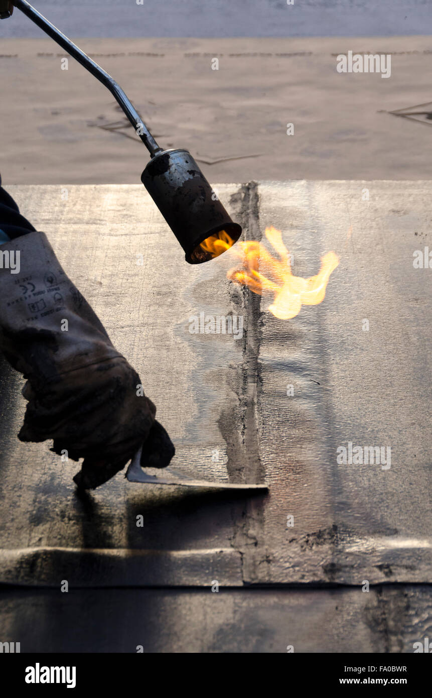 flame during welding of a waterproofing membrane on a roof Stock Photo ...