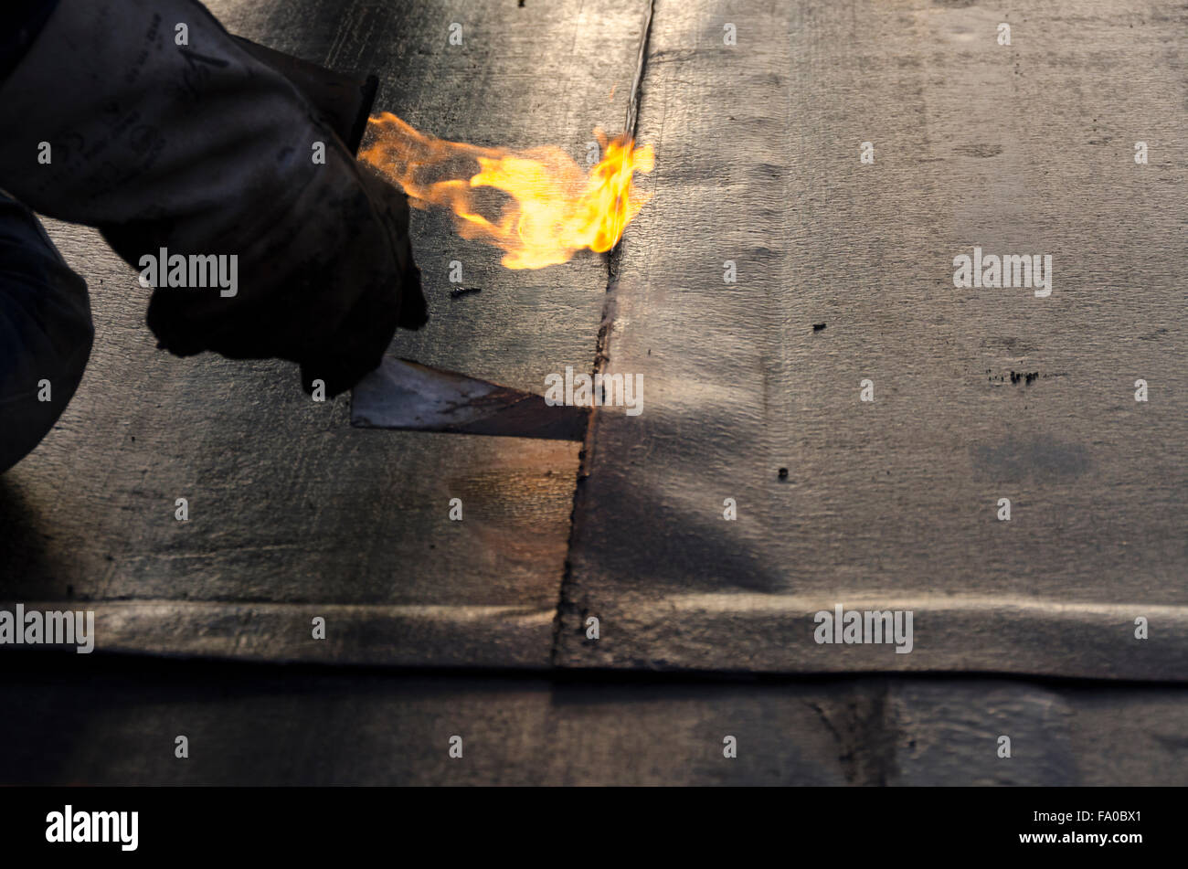 flame during welding of a waterproofing membrane on a roof Stock Photo ...