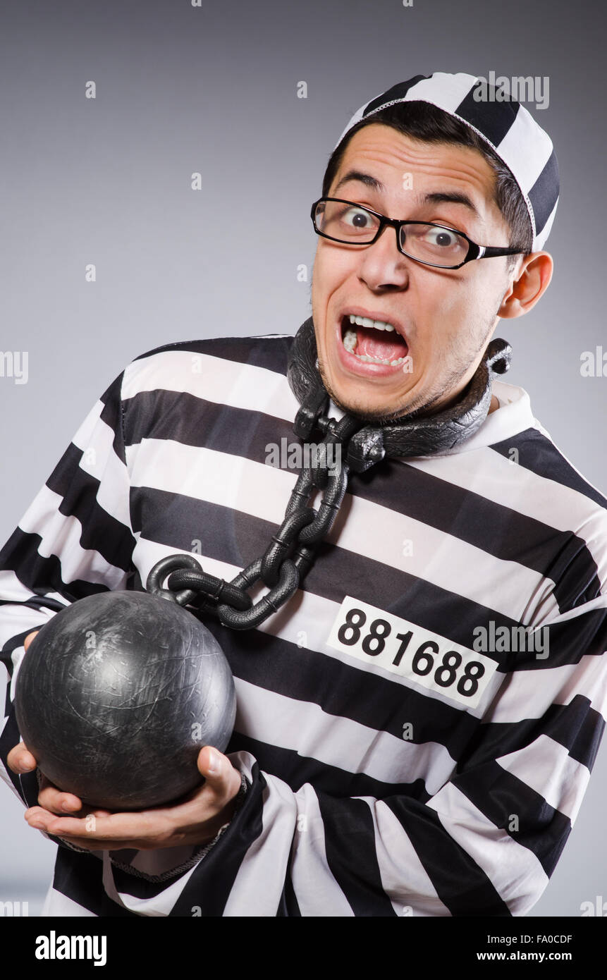 Young prisoner in chains against gray Stock Photo - Alamy