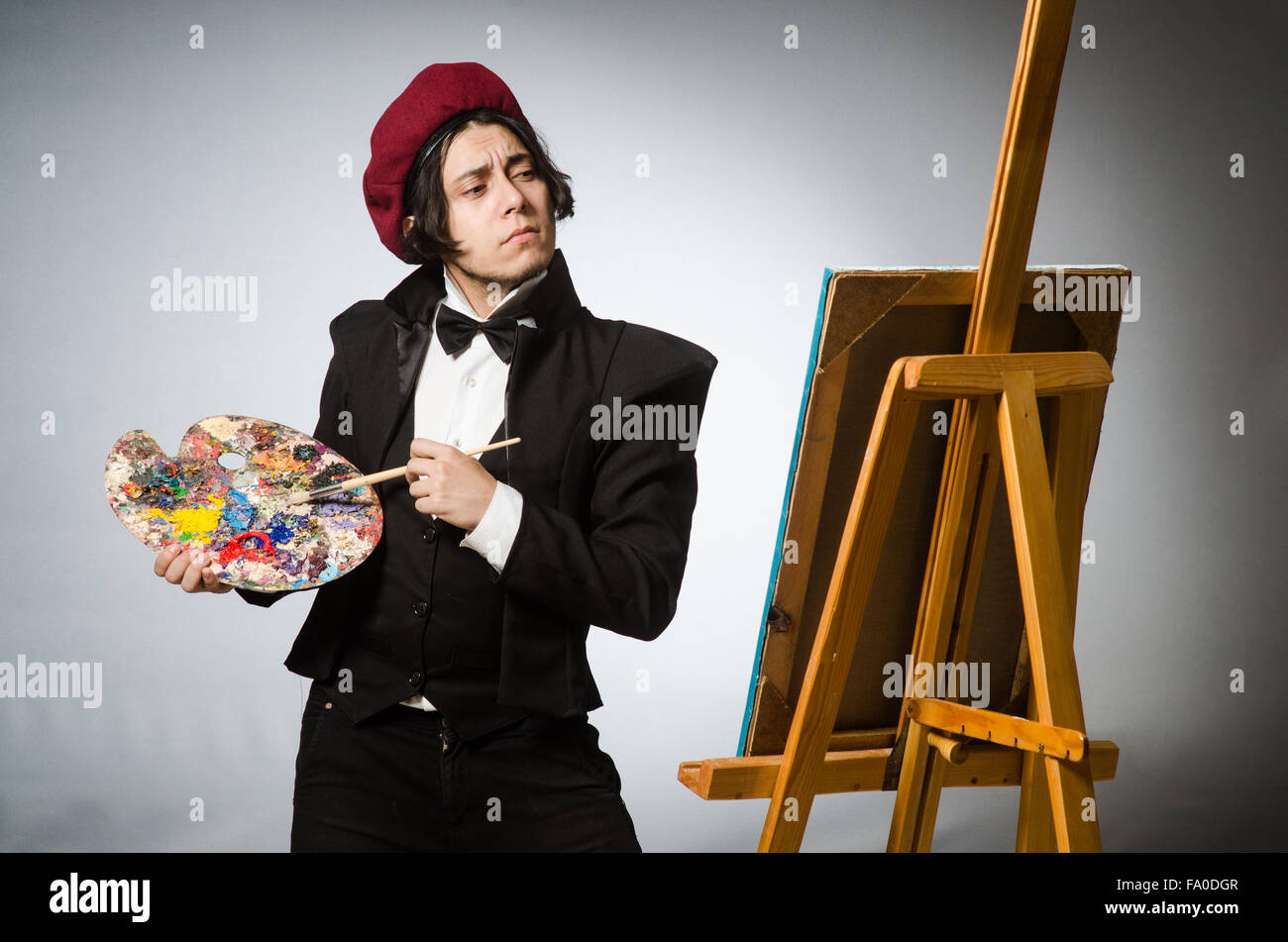 Funny artist in dark studio Stock Photo - Alamy