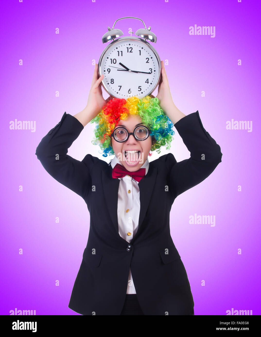 Funny clown with clock on white Stock Photo - Alamy