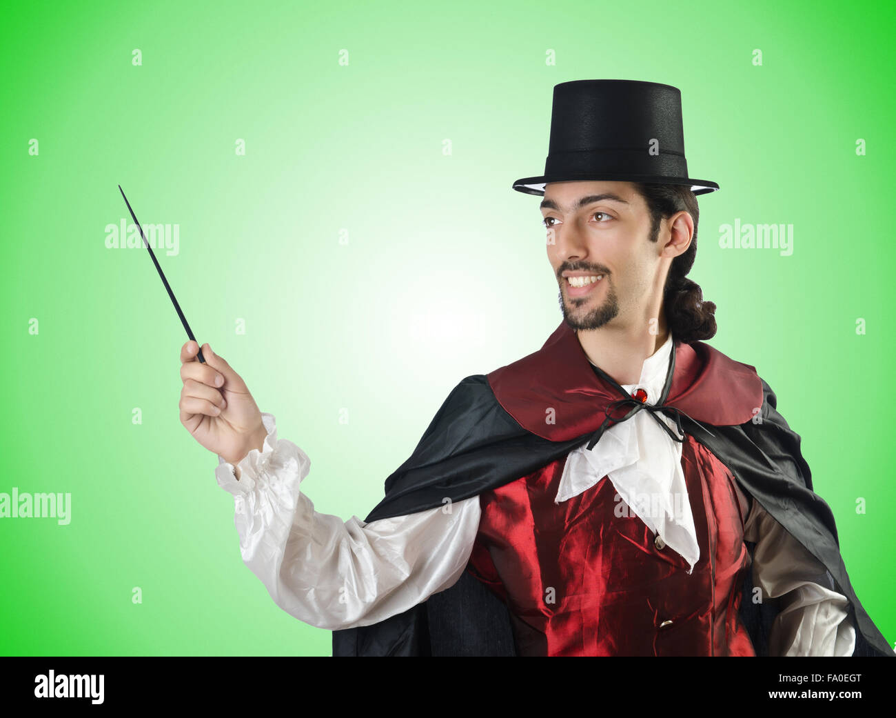 Magician doing tricks on white Stock Photo - Alamy