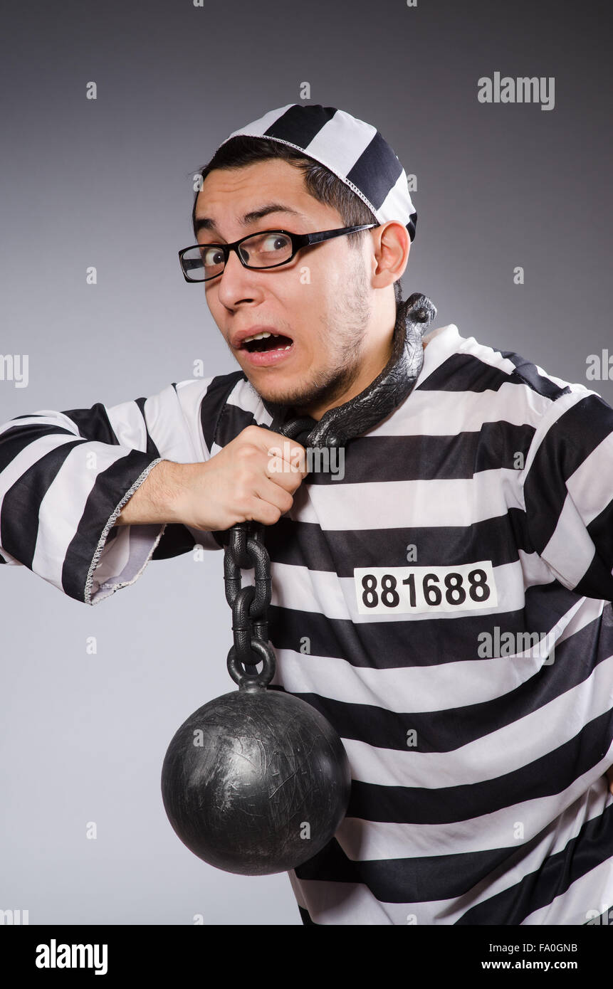Funny prisoner in chains isolated on gray Stock Photo - Alamy